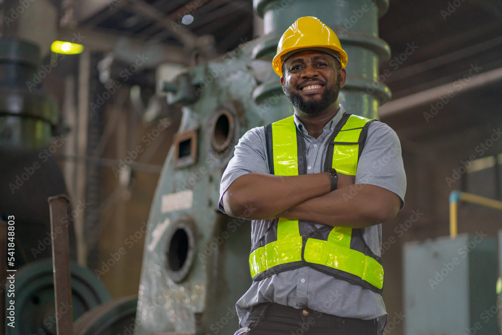 Portrait of African American factory worker stand with arm crossed also ...