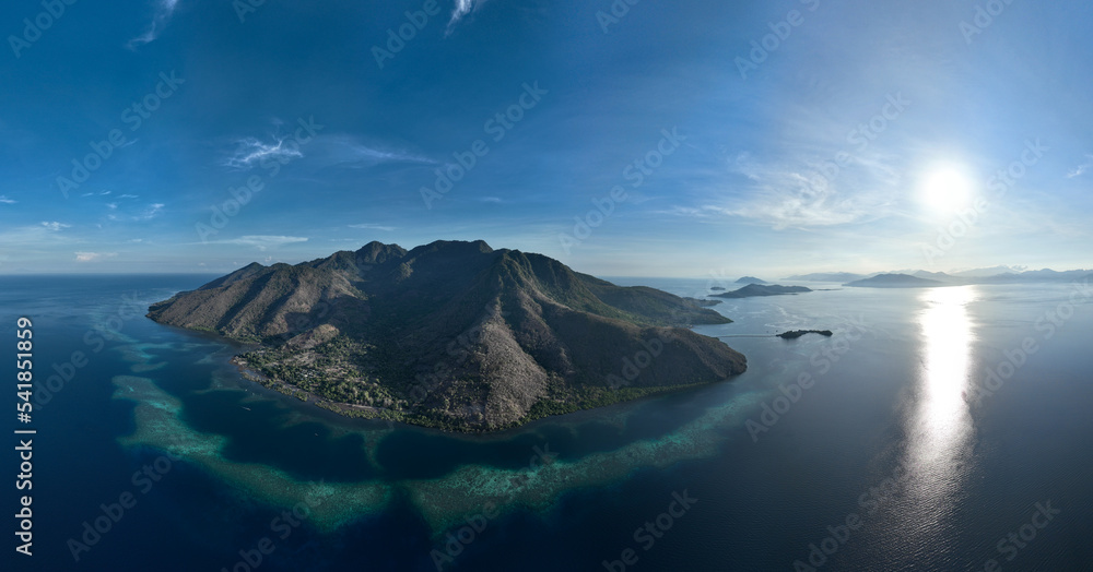 Pulau Besar, a volcanic island north of Flores, Indonesia, is ringed by ...