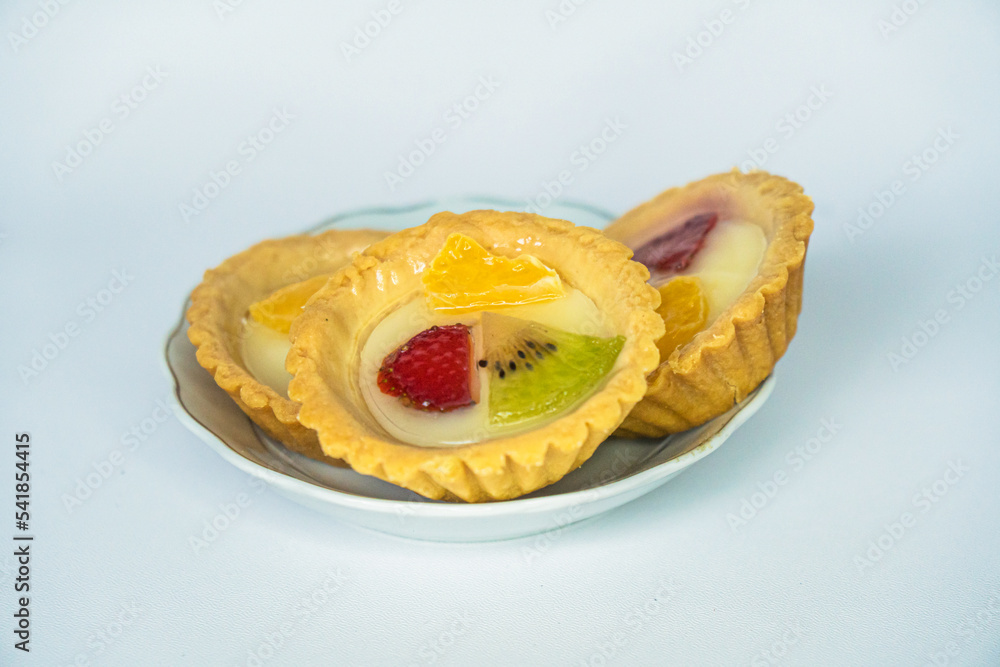 A small plate of a typical Indonesian snack called Pie Susu topped with ...