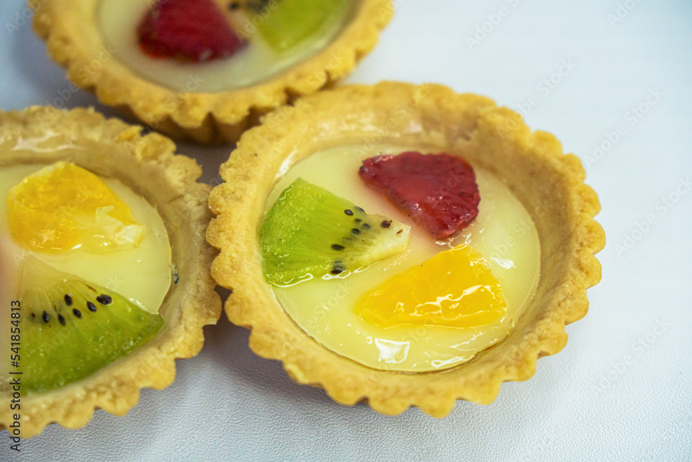 A small plate of a typical Indonesian snack called Pie Susu topped with ...