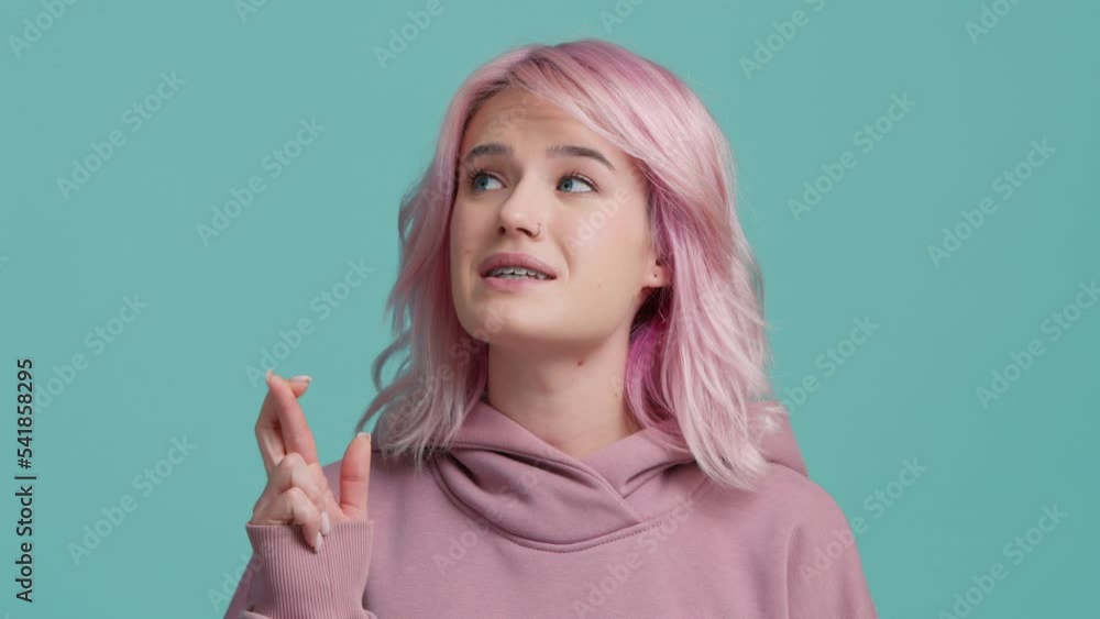 Young pleading cute hipster student with pastel pink hair, in pale ...