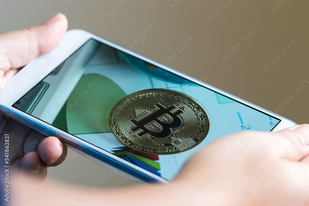 Bitcoin digital currency on screen smartphone. Cryptocurrency investor ...