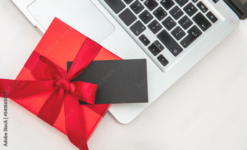 Red gift box and computer laptop on white background, top view, Stock ...