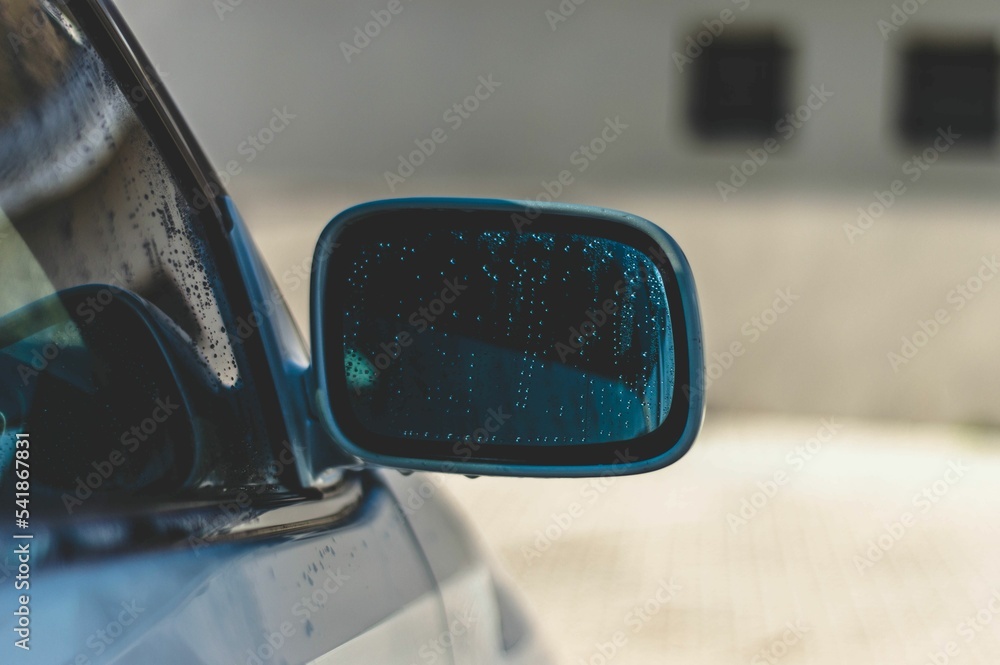 Closeup shot of a car mirror on a rainy day with blur background Stock ...