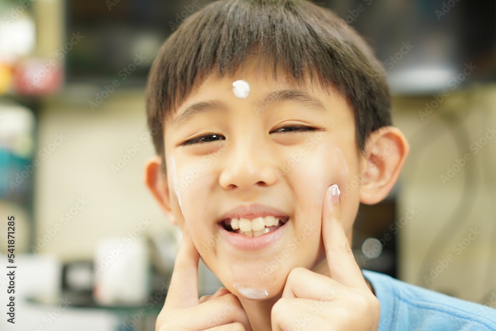 Skin care: The picture shows a kid applying The picture shows a young ...