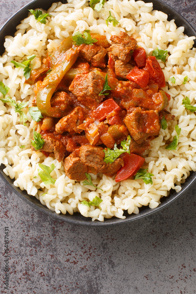Porkolt Hungarian Beef Paprika Stew served with Noodles closeup on the ...
