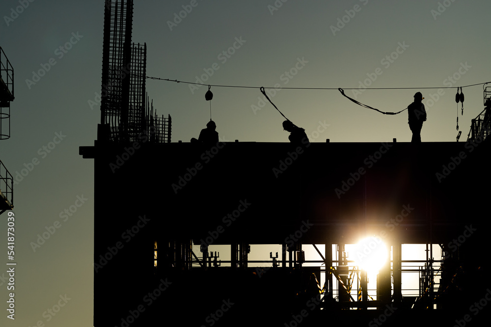 Builder workers working on construction site and sunset, beam, steel ...
