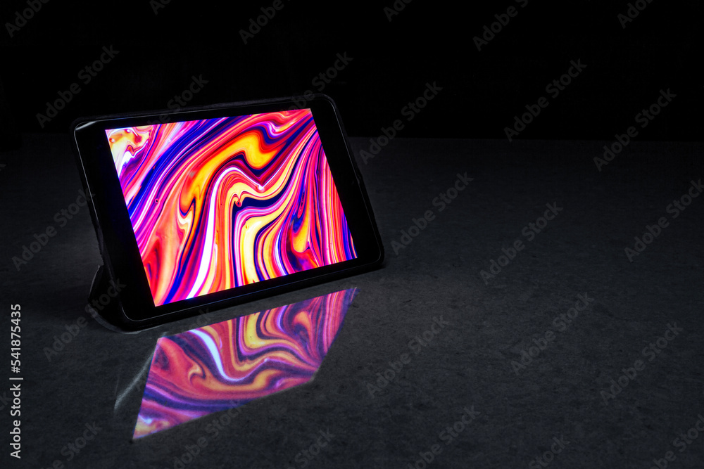 Digital Tablet with a Colorful Screen on a Black Background Stock Photo ...