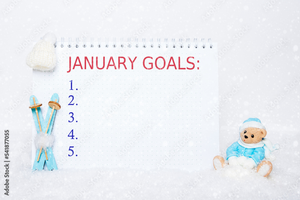 Teddy bear in blue clothes sitting on a sled, blue wooden skis, a white ...