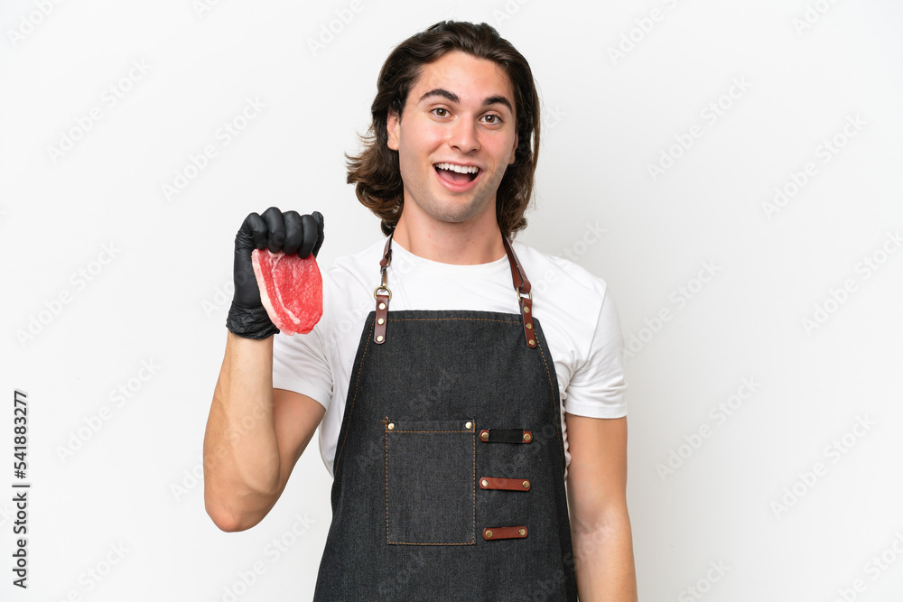 Butcher handsome man wearing an apron and serving fresh cut meat ...
