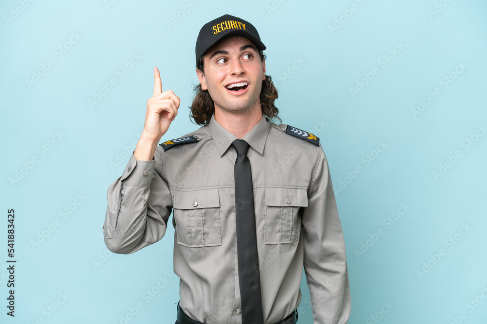 Young safeguard man isolated on blue background intending to realizes ...