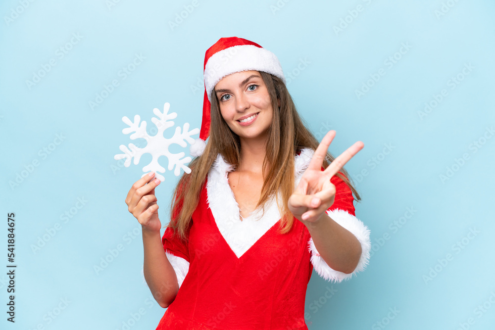 Young caucasian woman dressed as mama noel holding snowflake isolated ...