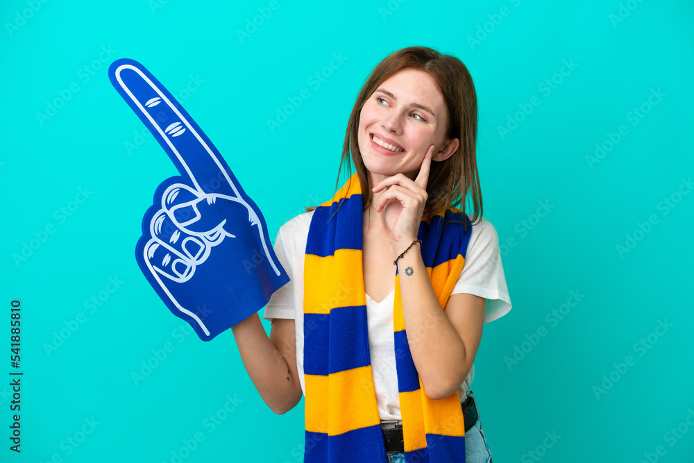 Young sports fan woman isolated on blue background thinking an idea ...