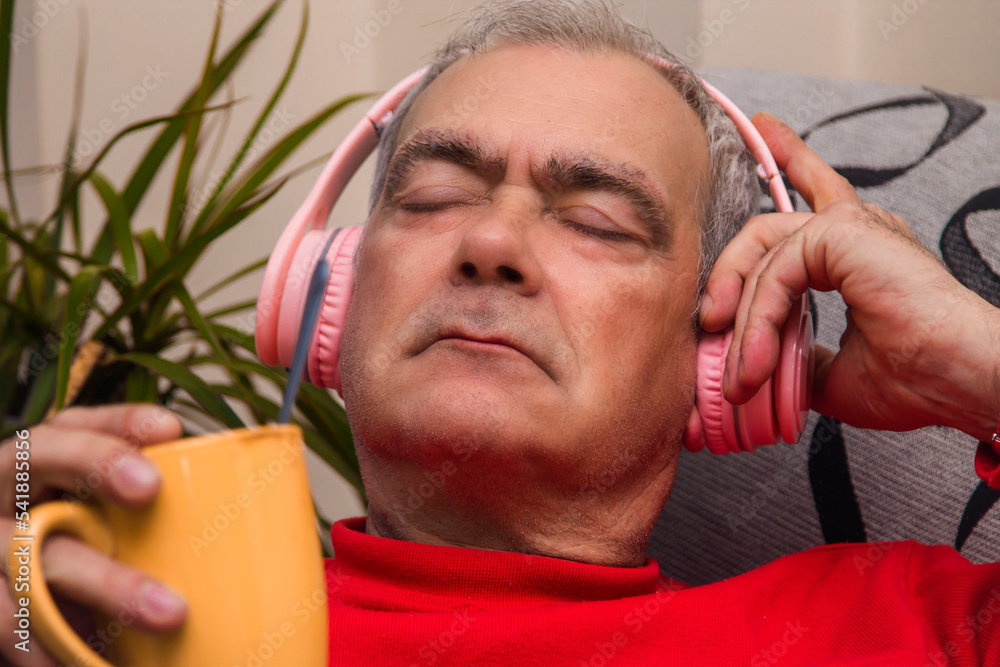relaxed man with headphones and coffee cup at home Stock Photo | Adobe ...