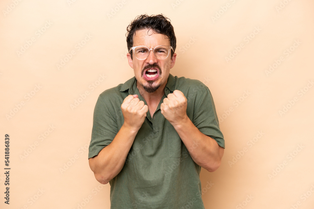 Young caucasian man isolated on beige background frustrated by a bad ...