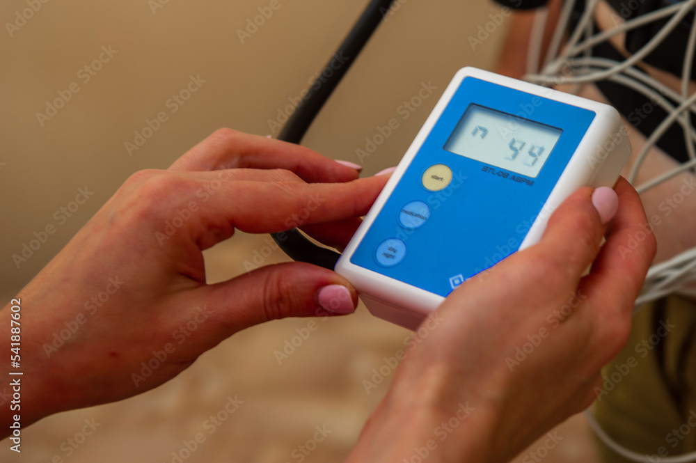 Electrocardiogram, ECG in hand. Clinic of Cardiology heart rate and ...