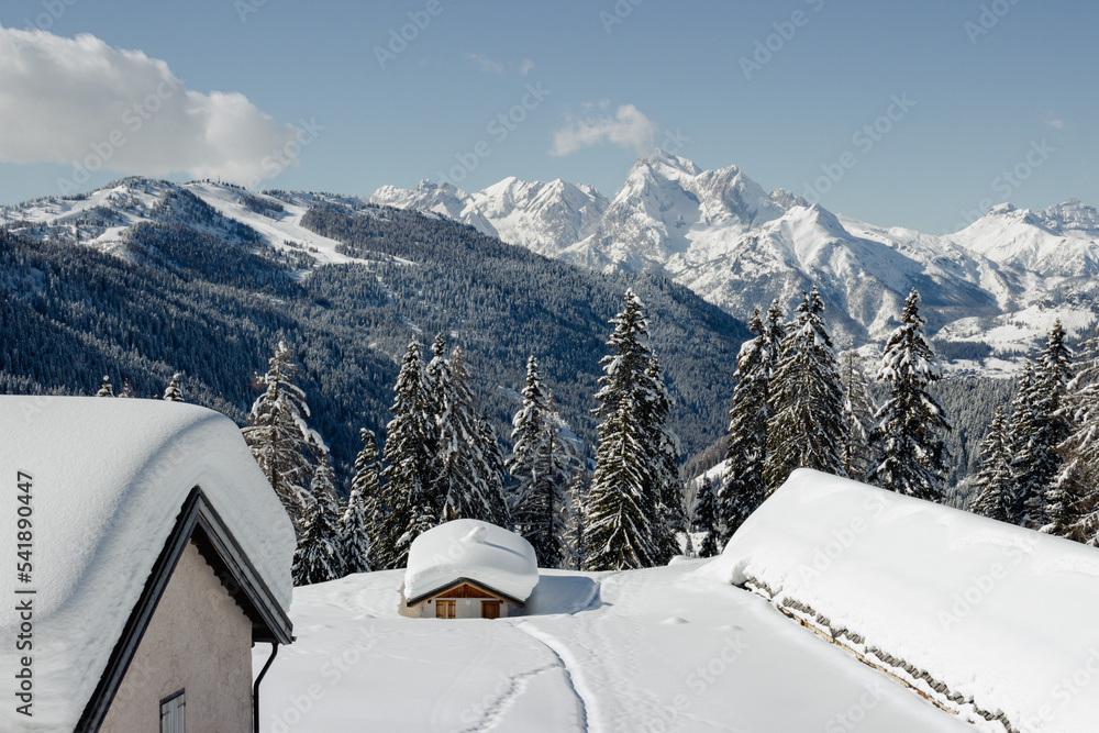 Alpine winter landscape. Ancient houses covered with snow with the ...