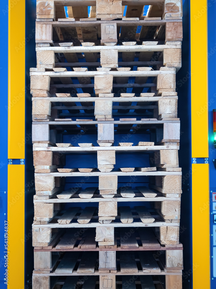 Wooden pallets are stacked on top of each other. Old pallets inside ...