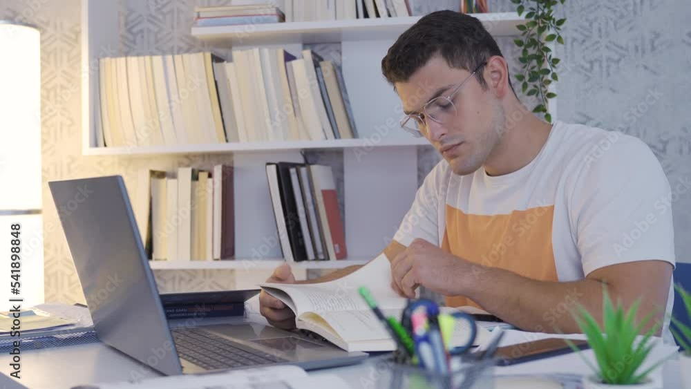 University student reading a book. The student is reading a book at ...