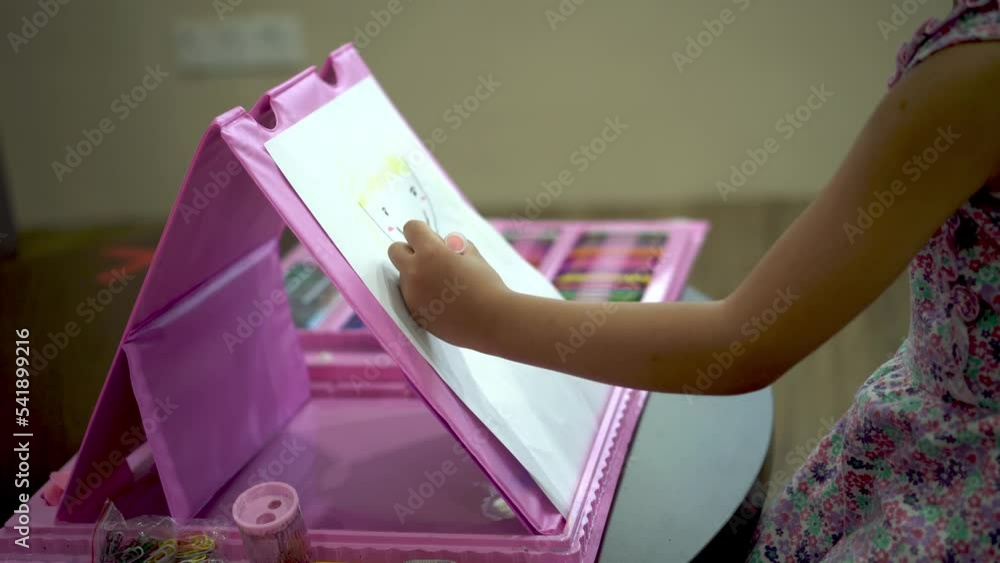 Little girl draw at paper. Preschool activity during COVID-19 pandemic ...