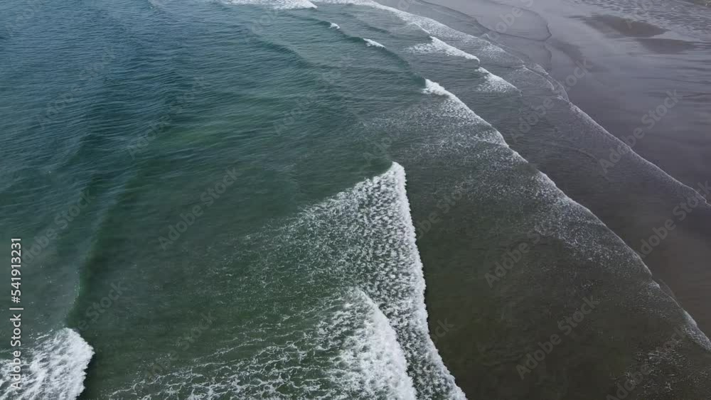 A deserted beach with wet sand and beautiful tidal waves. White sea ...