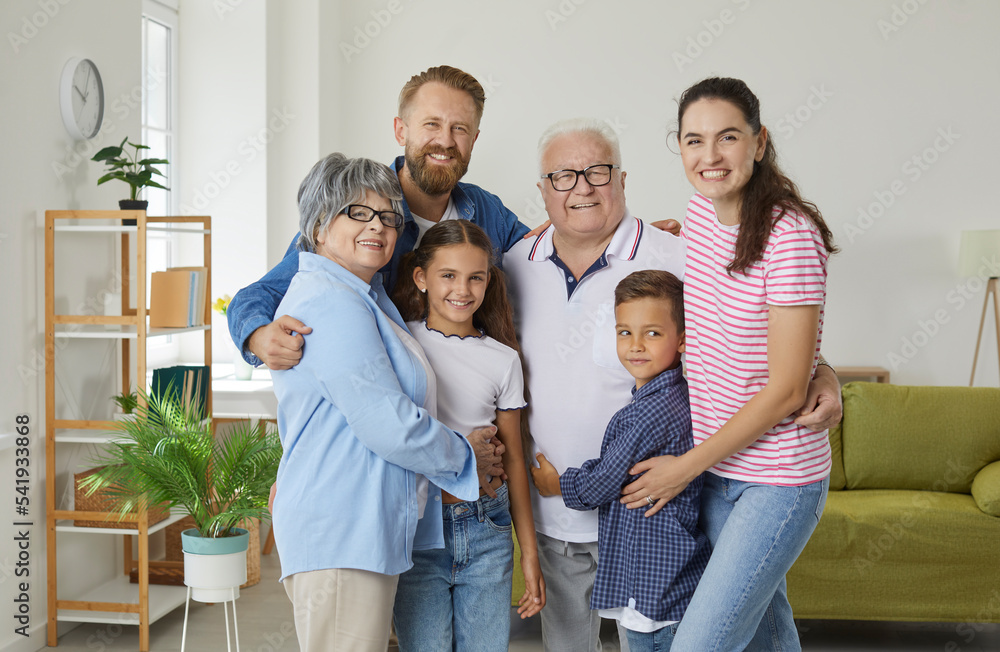 Portrait of happy family with three generations from grandchildren to ...
