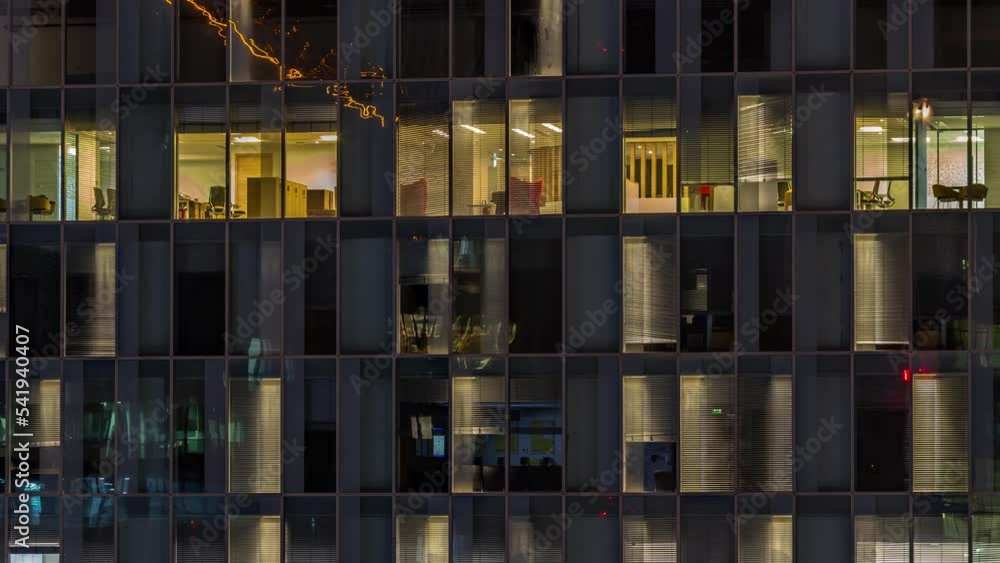 Night aerial view of office building glass window facade with ...