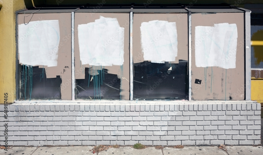 Shuttered store front with blocked out windows. Stock Photo | Adobe Stock