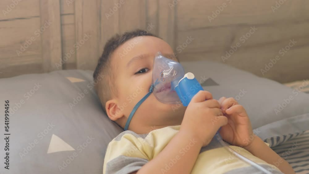 Little 2 years old boy does therapeutic inhalation using a nebulizer ...