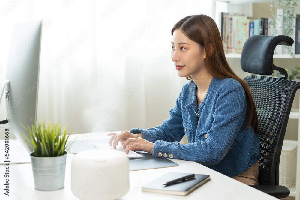 Modern air humidifier device during sitting workplace, happy asian ...