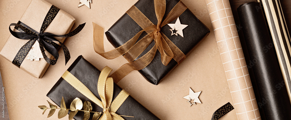 Christmas background with gift boxes and rolls of kraft wrapping paper ...