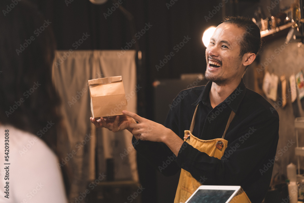 waiter handing and present bakery with smiling to customer and watching ...