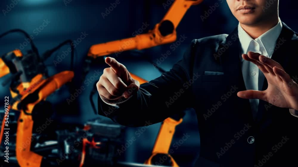 Engineer use cybernated robotic software to control industry robot arm ...