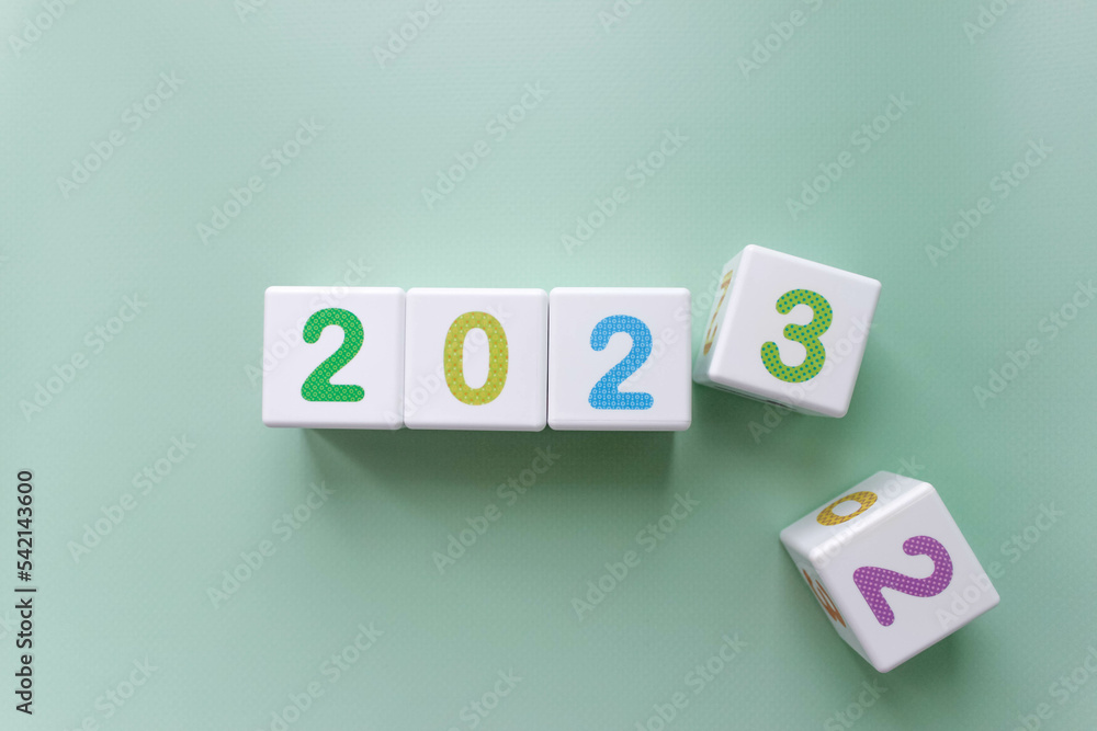 Cubes with colorful numbers on a green background. Year change concept ...
