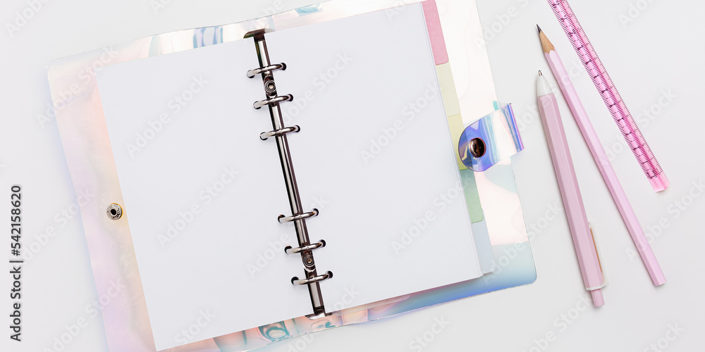 Open spiral notebook with colorful gradient cover, pen, pencil, ruler ...