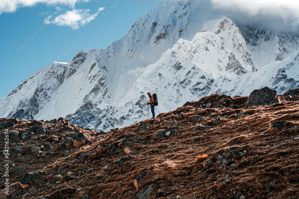 Solo hiker exploring high altitude sunny mountains. Outdoor tourist ...