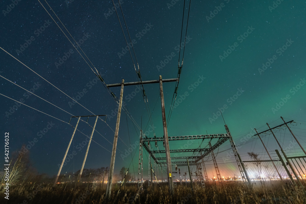 Beautiful night Aurora over electrical substation and wooden pole power ...
