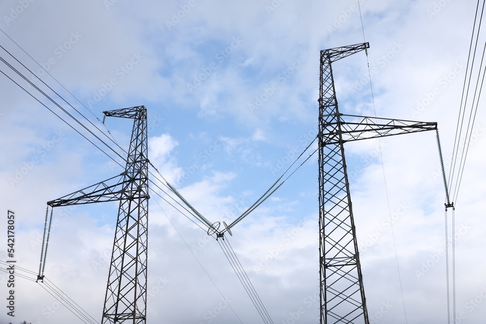 High-voltage towers with electricity transmission power lines against ...