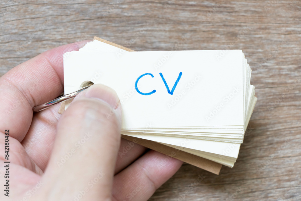 Hand hold flash card with handwriting in word CV (Abbreviation of ...