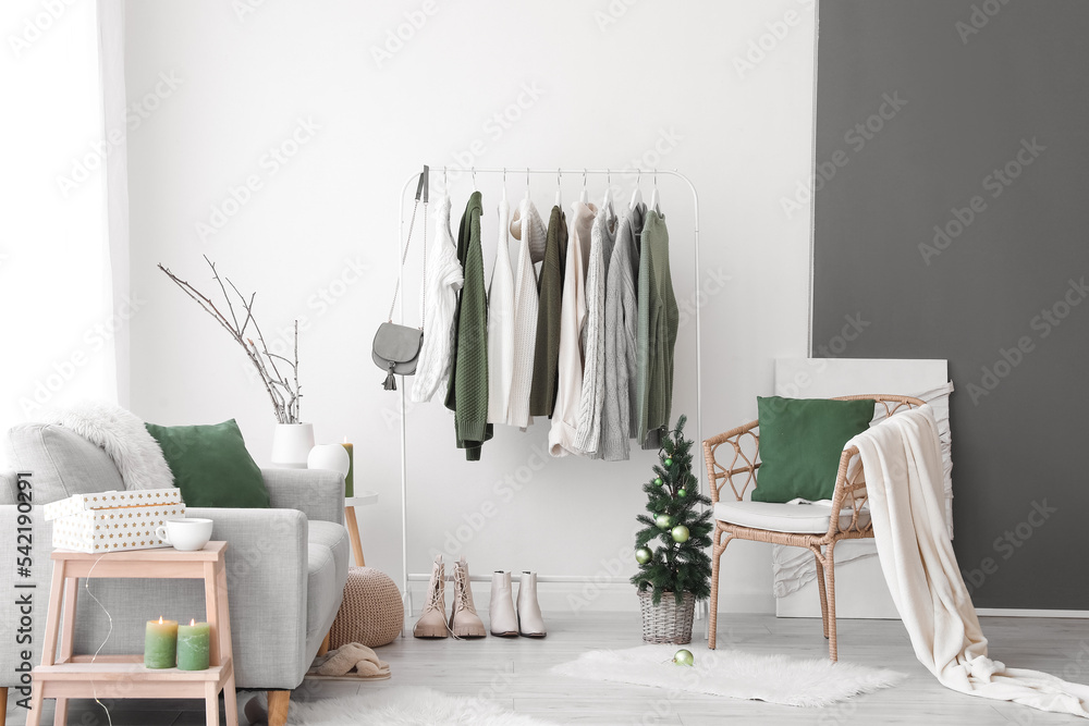Stylish interior of dressing room with rack and warm sweaters Stock ...