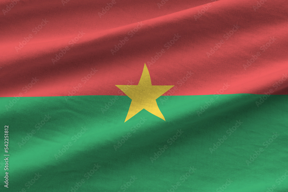 Burkina Faso flag with big folds waving close up under the studio light ...