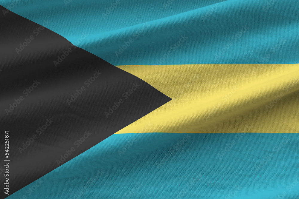 Bahamas flag with big folds waving close up under the studio light ...