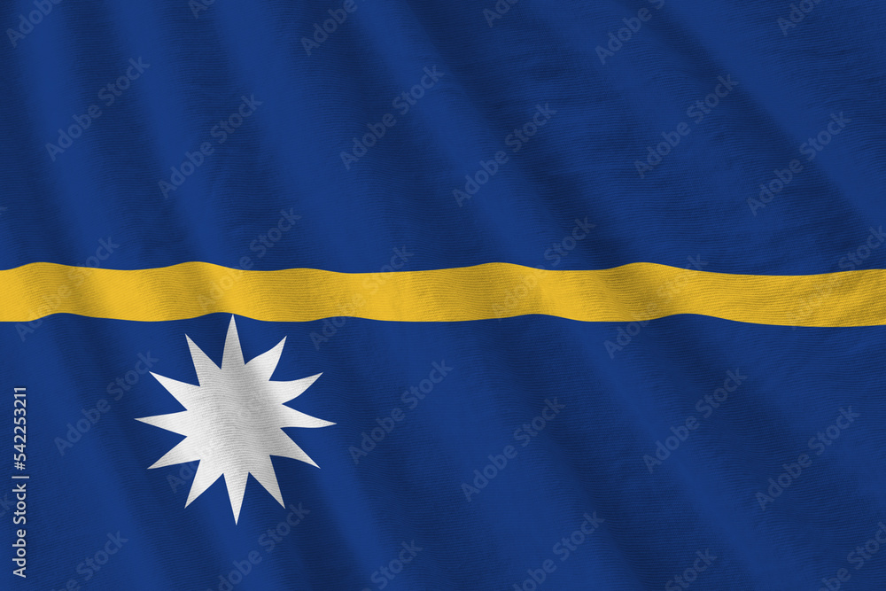 Nauru flag with big folds waving close up under the studio light ...