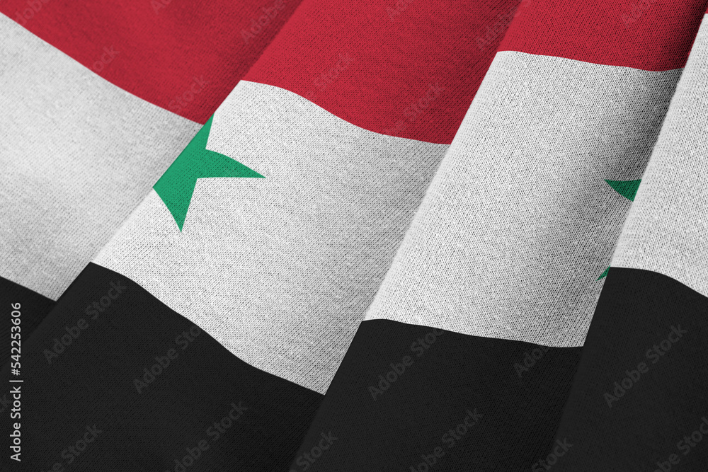 Syria flag with big folds waving close up under the studio light ...
