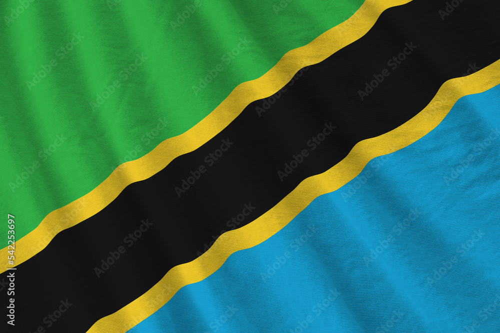 Tanzania flag with big folds waving close up under the studio light ...