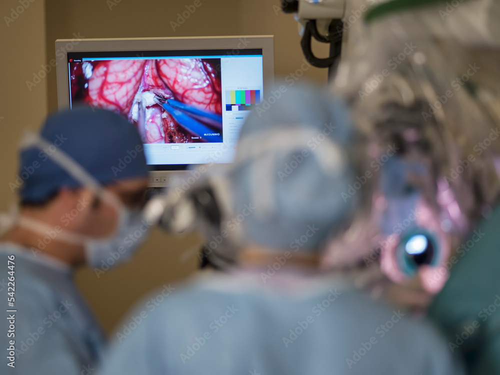 in neurosurgery surgery, neurosurgeons operate with microscopes with ...