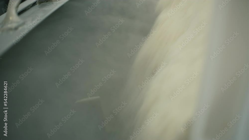 Close-up of pouring flour into industrial mixer. Clip. Filling mixing ...