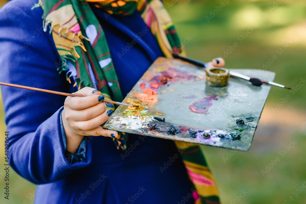 The girl picks up the pink color in the palette Stock Photo | Adobe Stock
