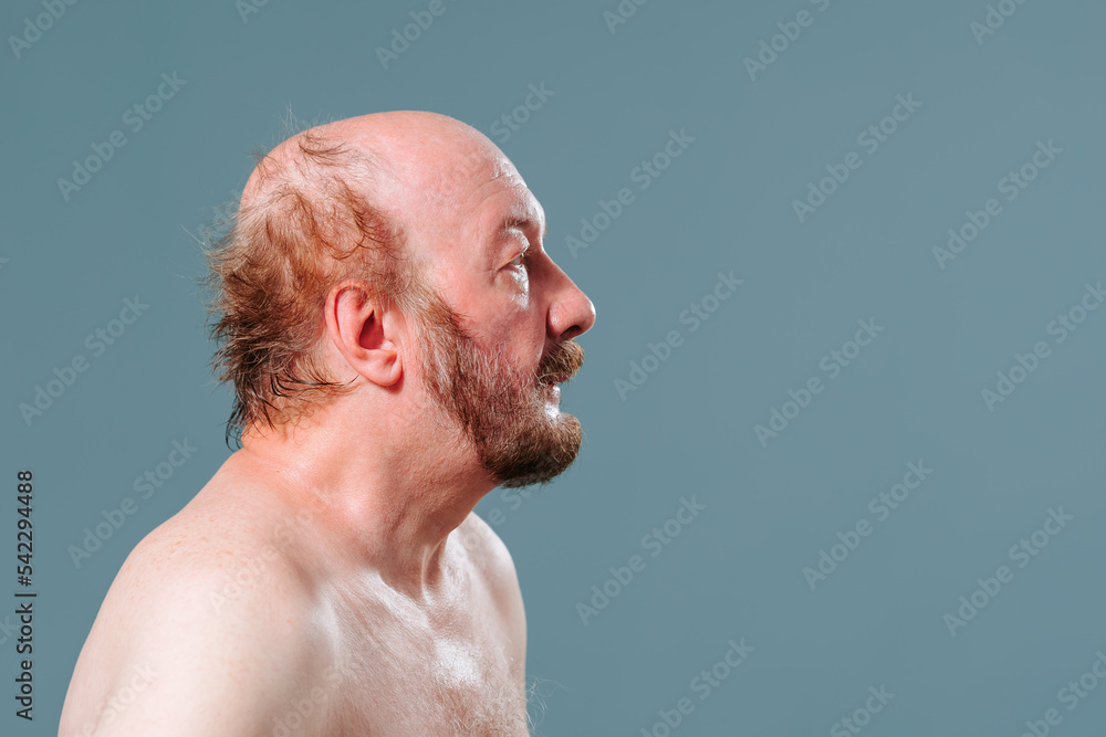 Senior man on the blue background of the studio side view profile ...
