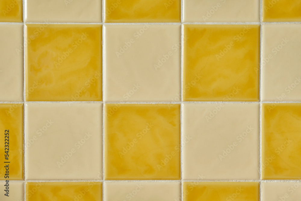 Close up photo of original retro 1970s tiles. Square orange and yellow ...